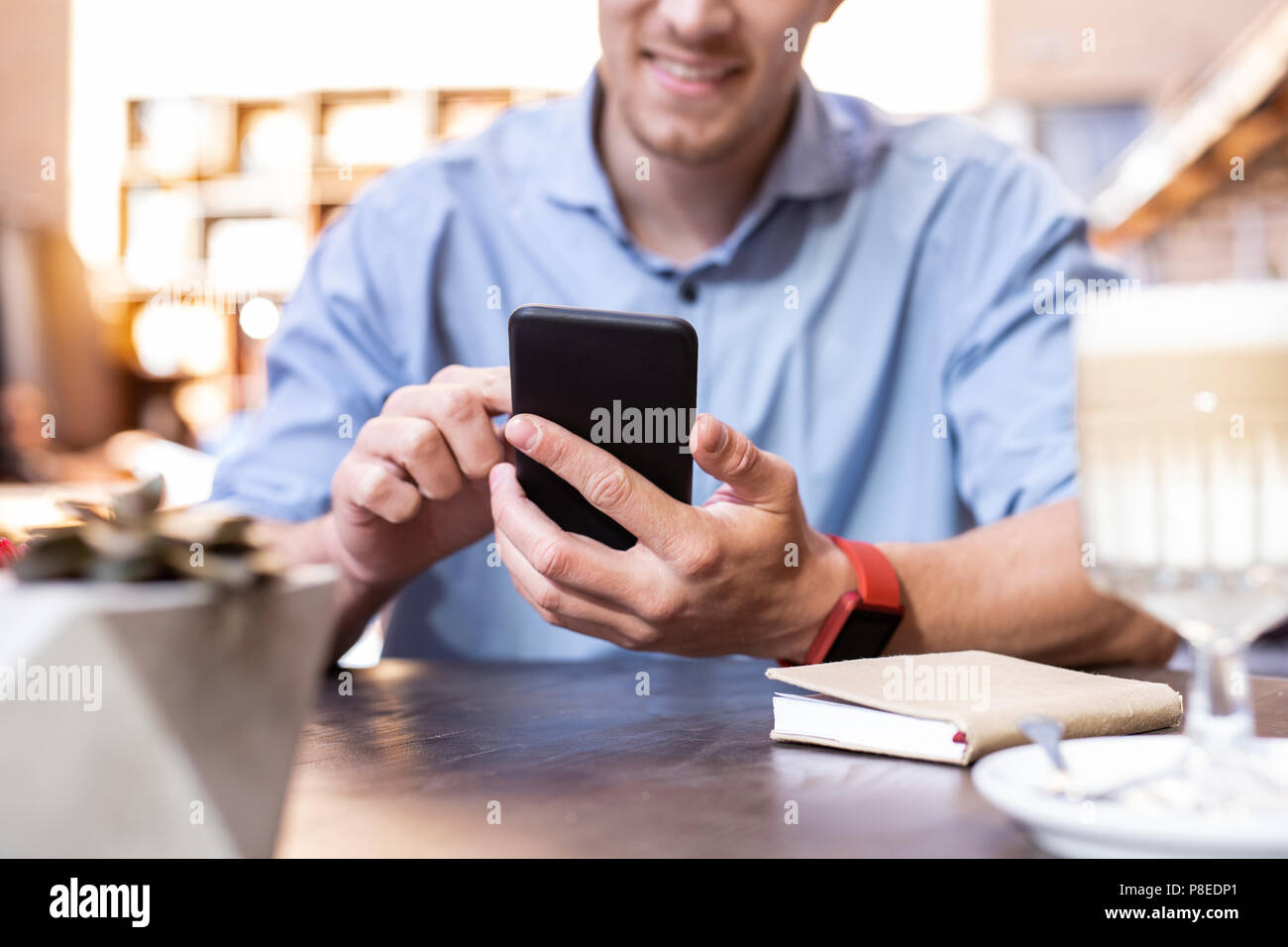 Beaming businessman making some important notes on phone Stock Photo ...