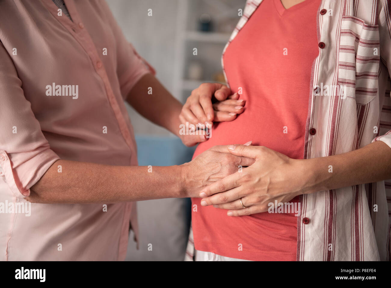 Pregnant daughter coming to her mature mother Stock Photo - Alamy