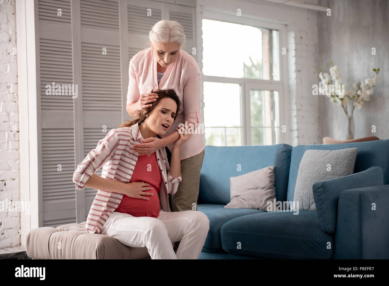 Loving woman nurturing her pregnant daughter Stock Photo - Alamy