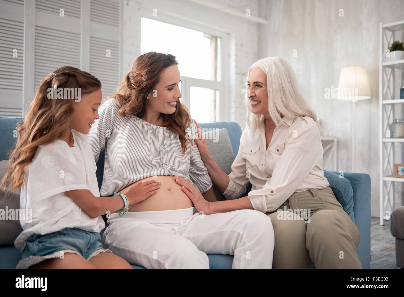 Pregnant woman coming to her mother with older daughter Stock Photo - Alamy