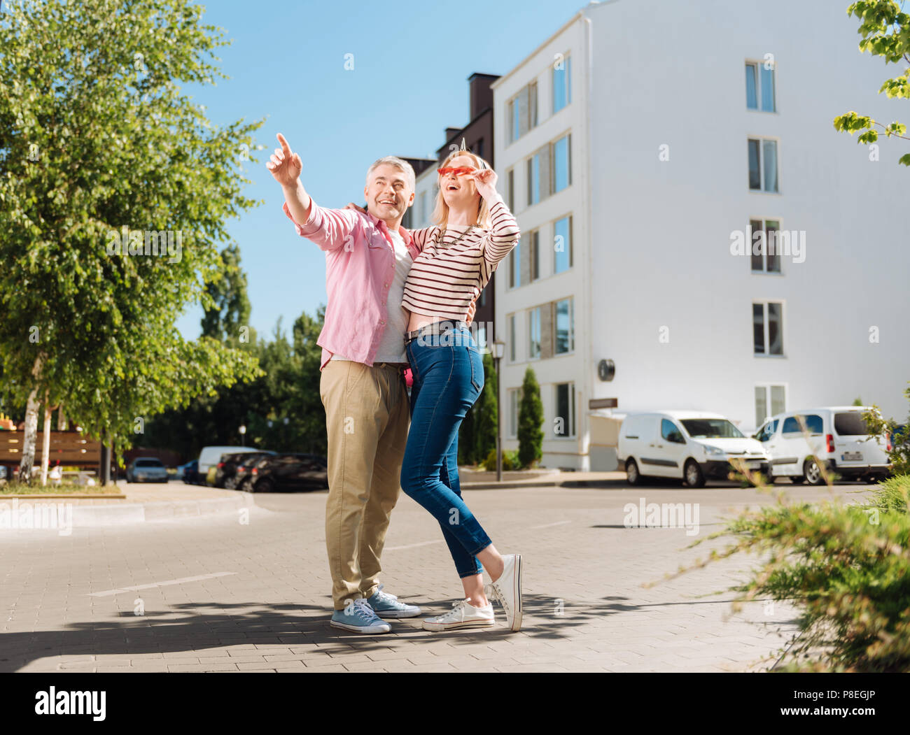Joyful positive man pointing with his finger Stock Photo - Alamy
