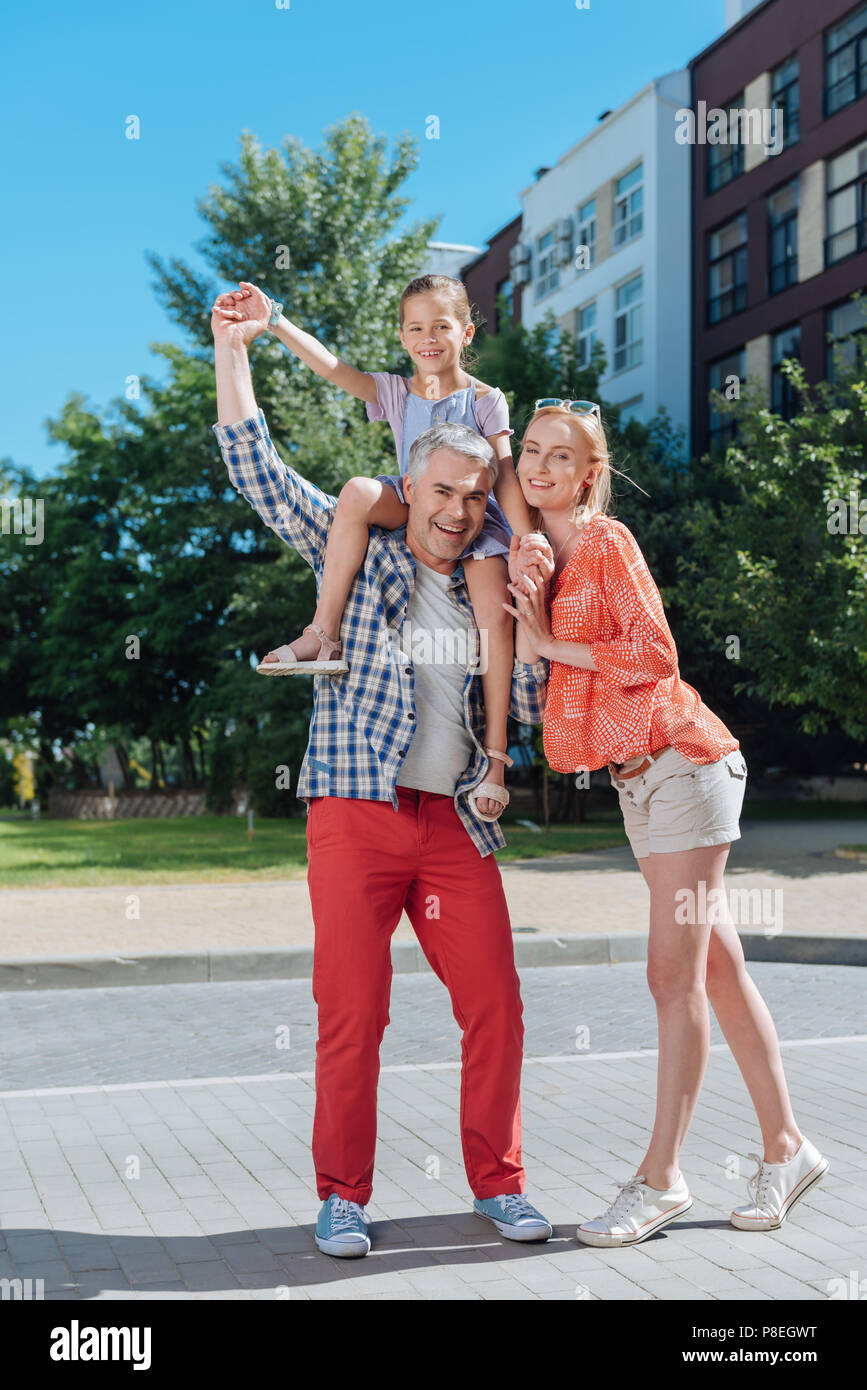 Nice joyful family standing together Stock Photo - Alamy