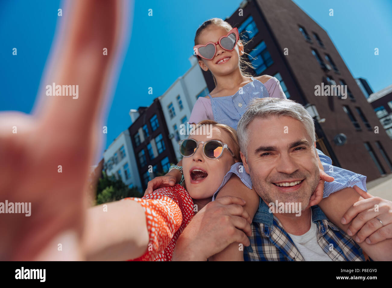 Cheerful nice family taking photos of themselves Stock Photo - Alamy Cheerful nice family taking photos of themselves Stock Photo - Alamy