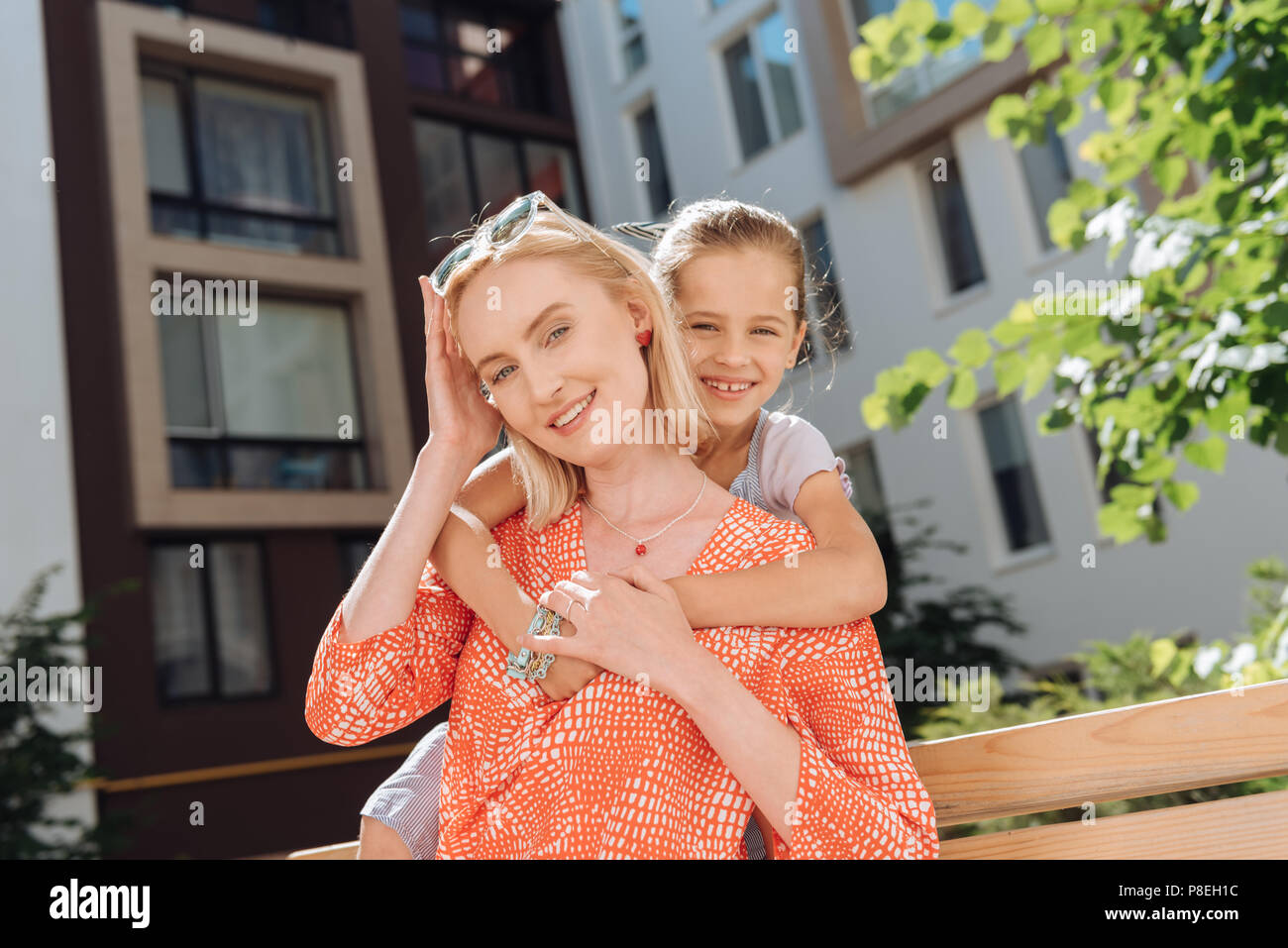 Delighted positive girl hugging her mother Stock Photo - Alamy