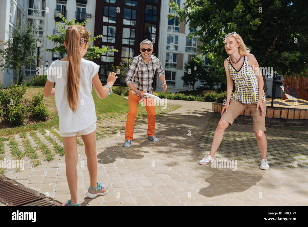 Delighted joyful family playing badminton Stock Photo - Alamy