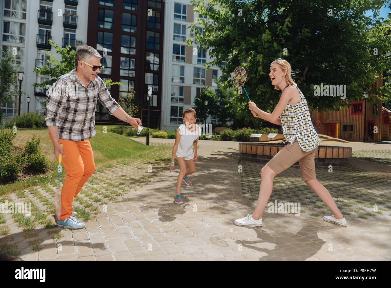 Delighted nice family playing together Stock Photo - Alamy