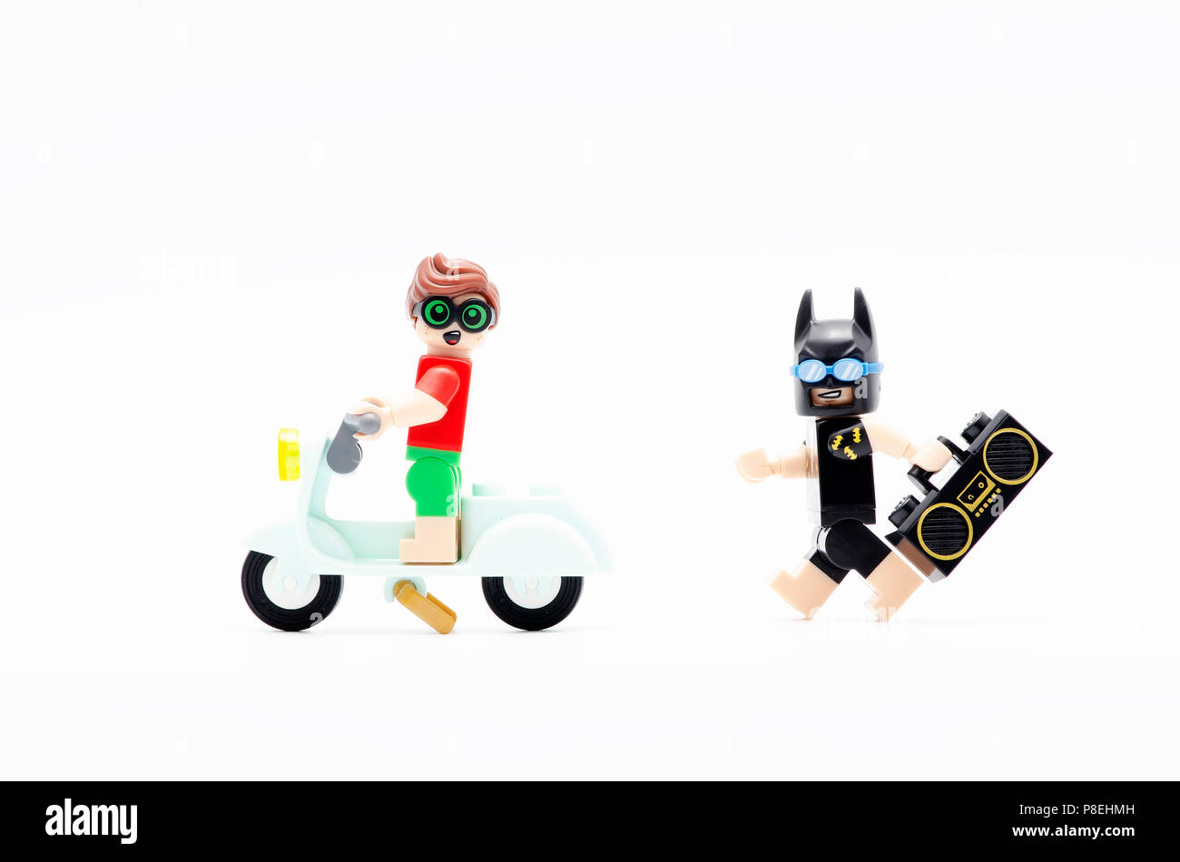 lego robin riding scooter with batman chasing him isolated on white ...