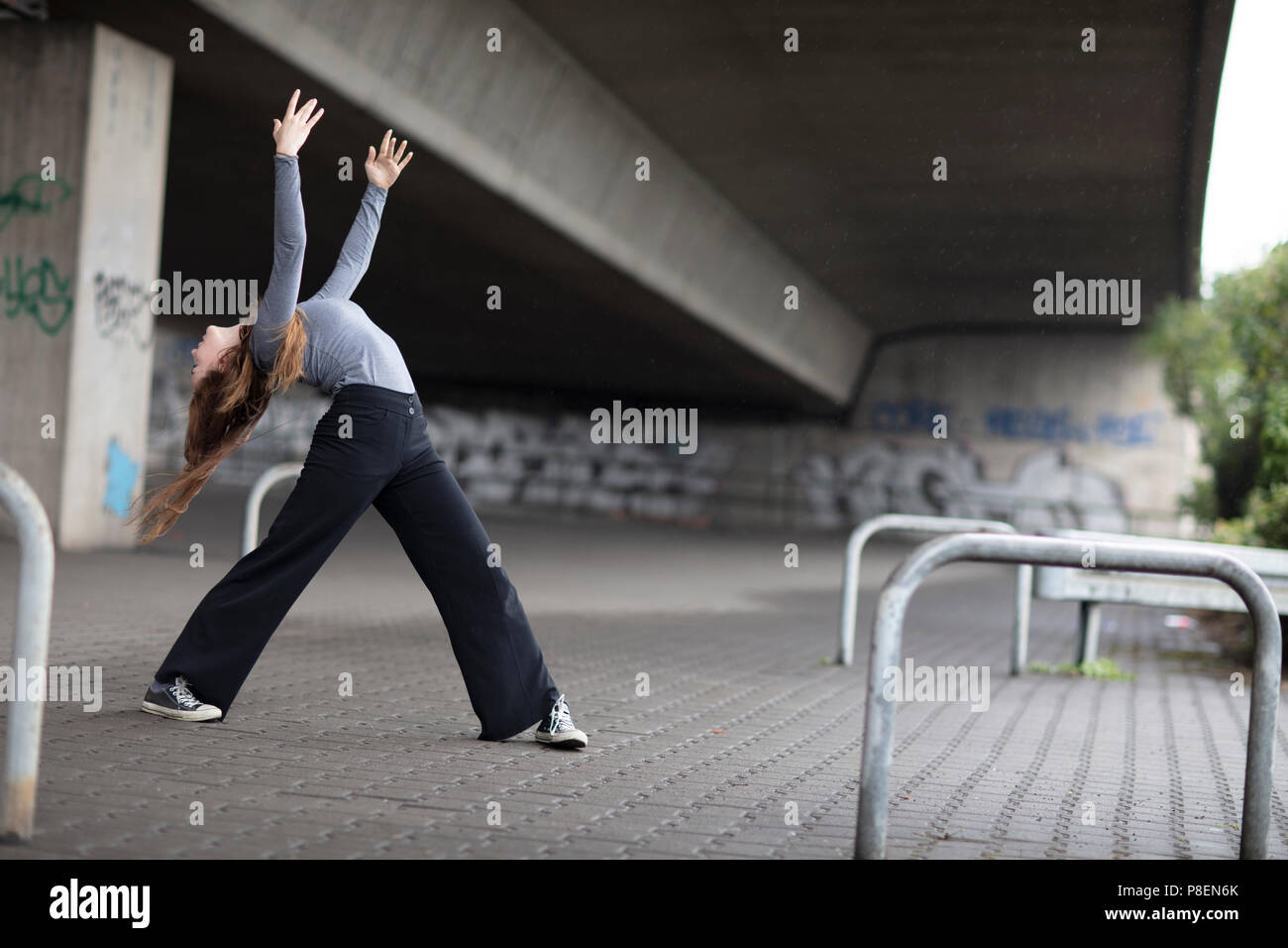 Female street dancer performing on a sidewalk. Full length Stock Photo ...