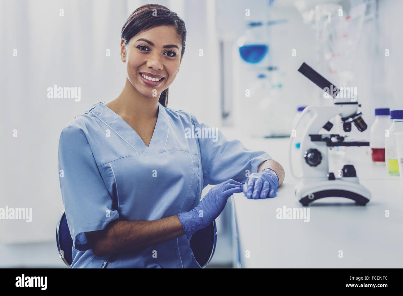 Beautiful young bioengineer wearing blue uniform Stock Photo - Alamy