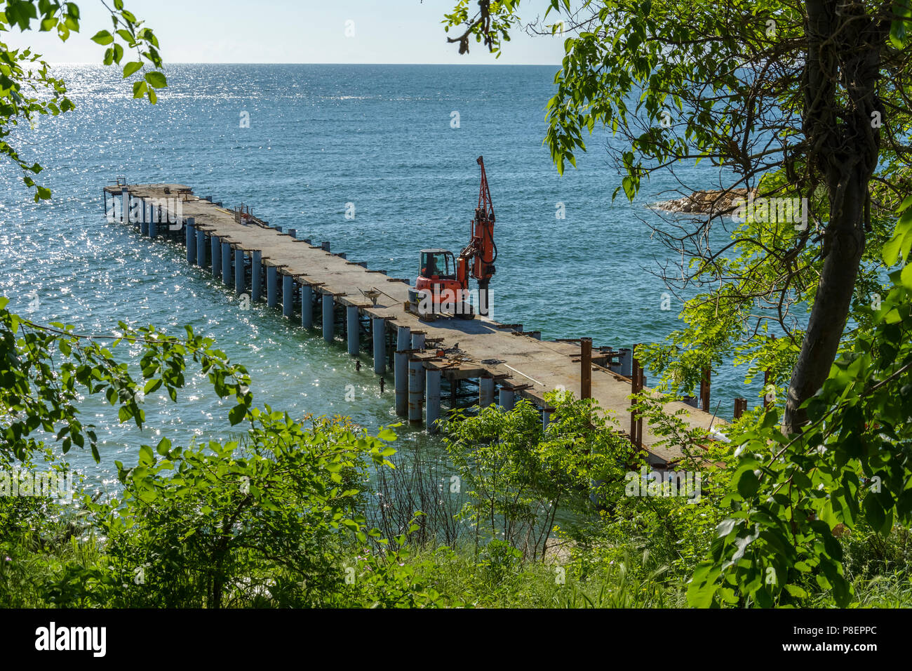 Drilling machine on a pier working, surrounded by water Stock Photo - Alamy