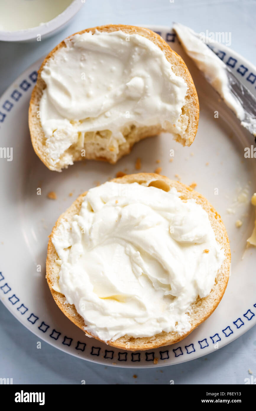 Roll with butter and cream cheese Stock Photo - Alamy