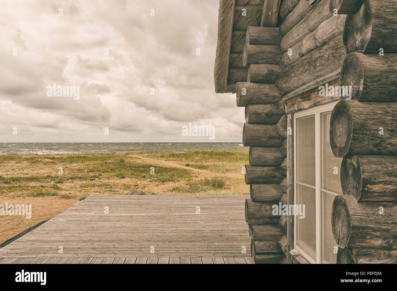 Log house of log houses with a window and a terrace on the shores of ...