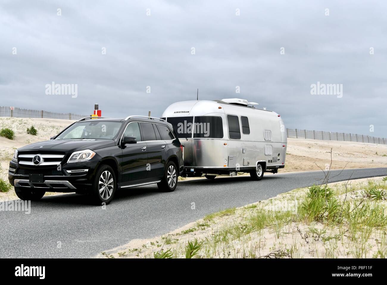 Black Mercedes Benz GL450 towing an Airstream Sport 22FB travel trailer ...