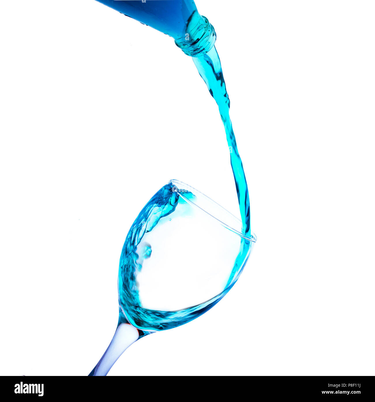 Light blue liquid drink pour in wine glass Stock Photo - Alamy