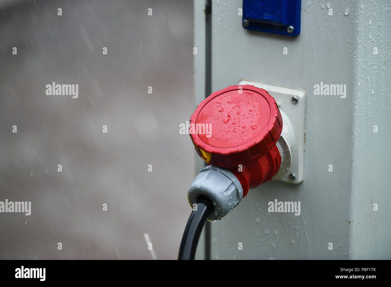 Raindrops are seen on industrial electric plug during heavy rain Stock ...