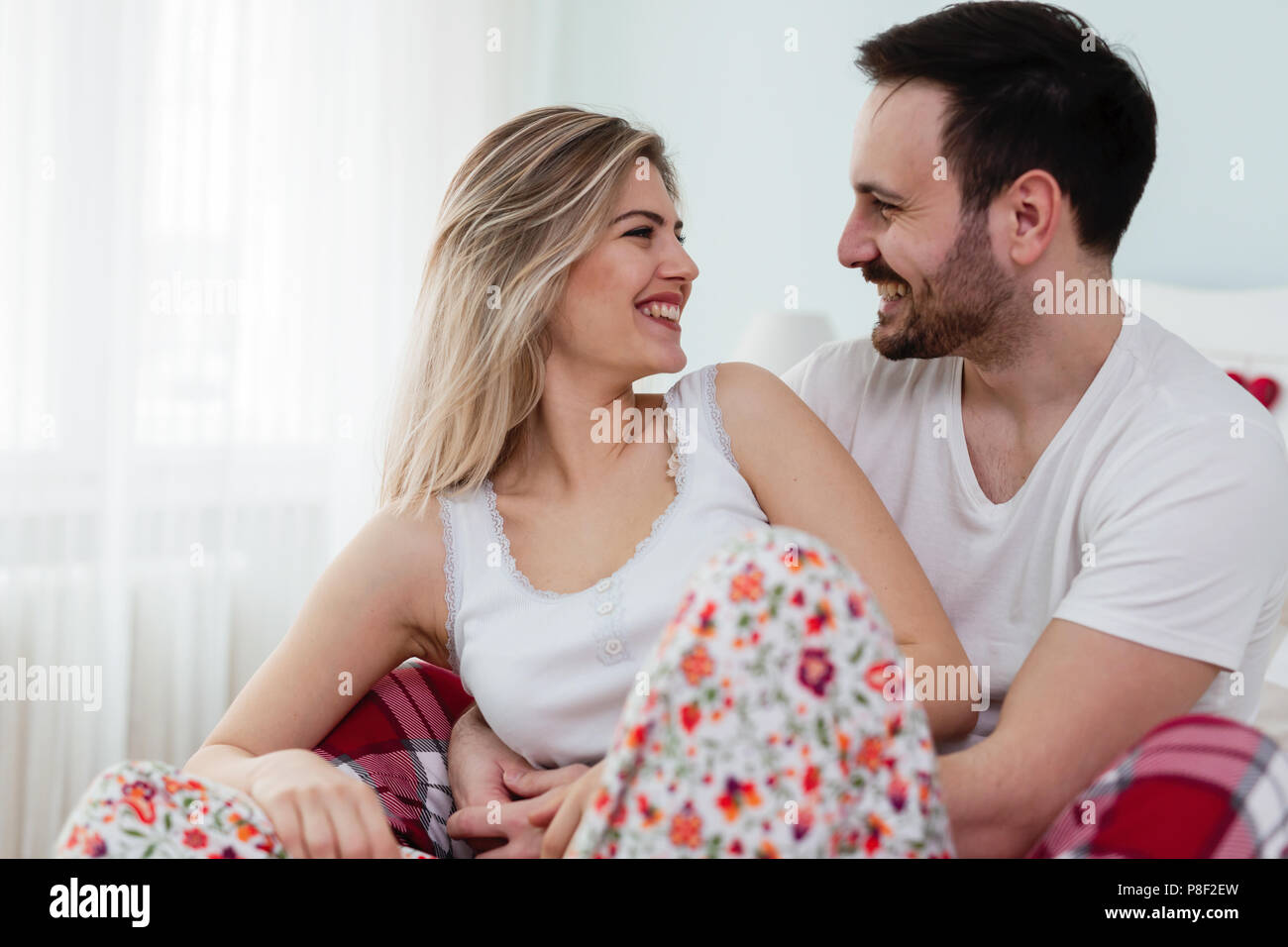 Young couple having romantic time in bedroom Stock Photo - Alamy