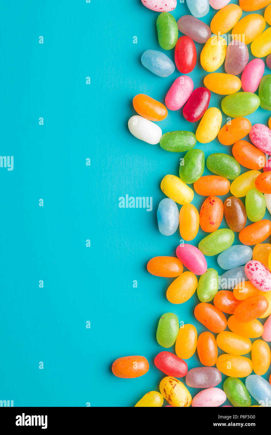 Sweet jelly beans on blue background Stock Photo - Alamy
