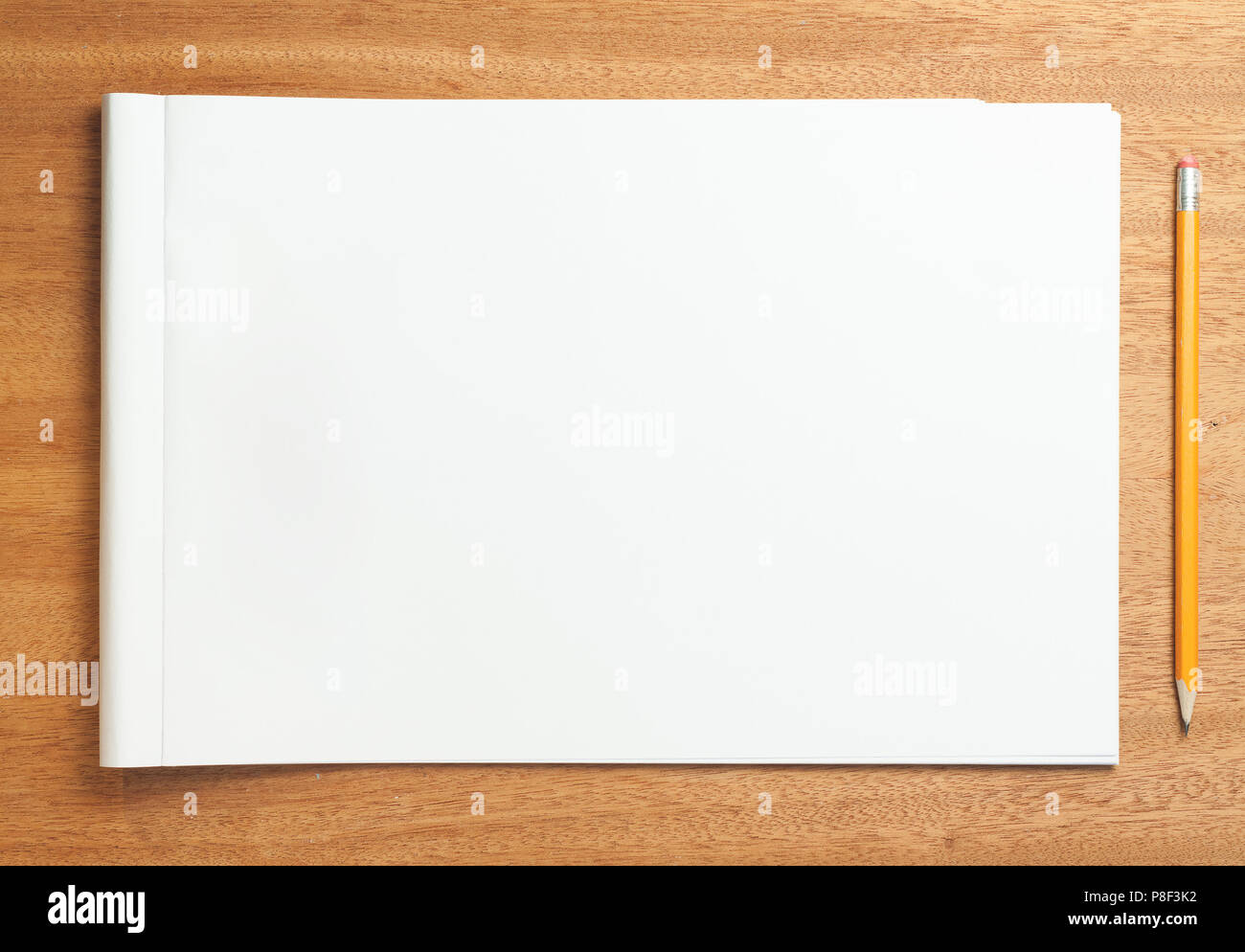 An empty sheet of sketchbook or album for drawing on wooden background ...