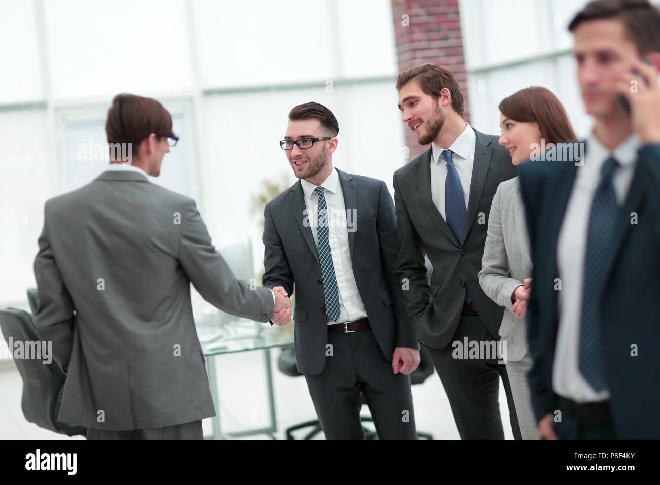 Confident young people, handshake and smile Stock Photo - Alamy
