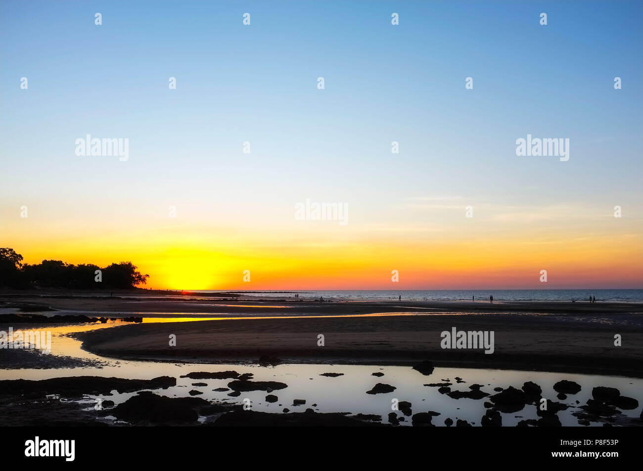 Nightcliff beach at sunset, with people silhouettes. In a suburb of ...