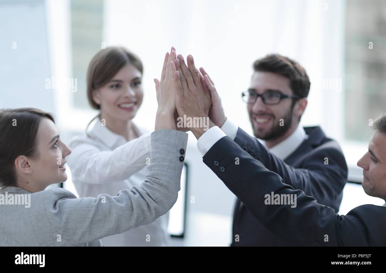 successful business team giving each other a high-five, standing in the ...