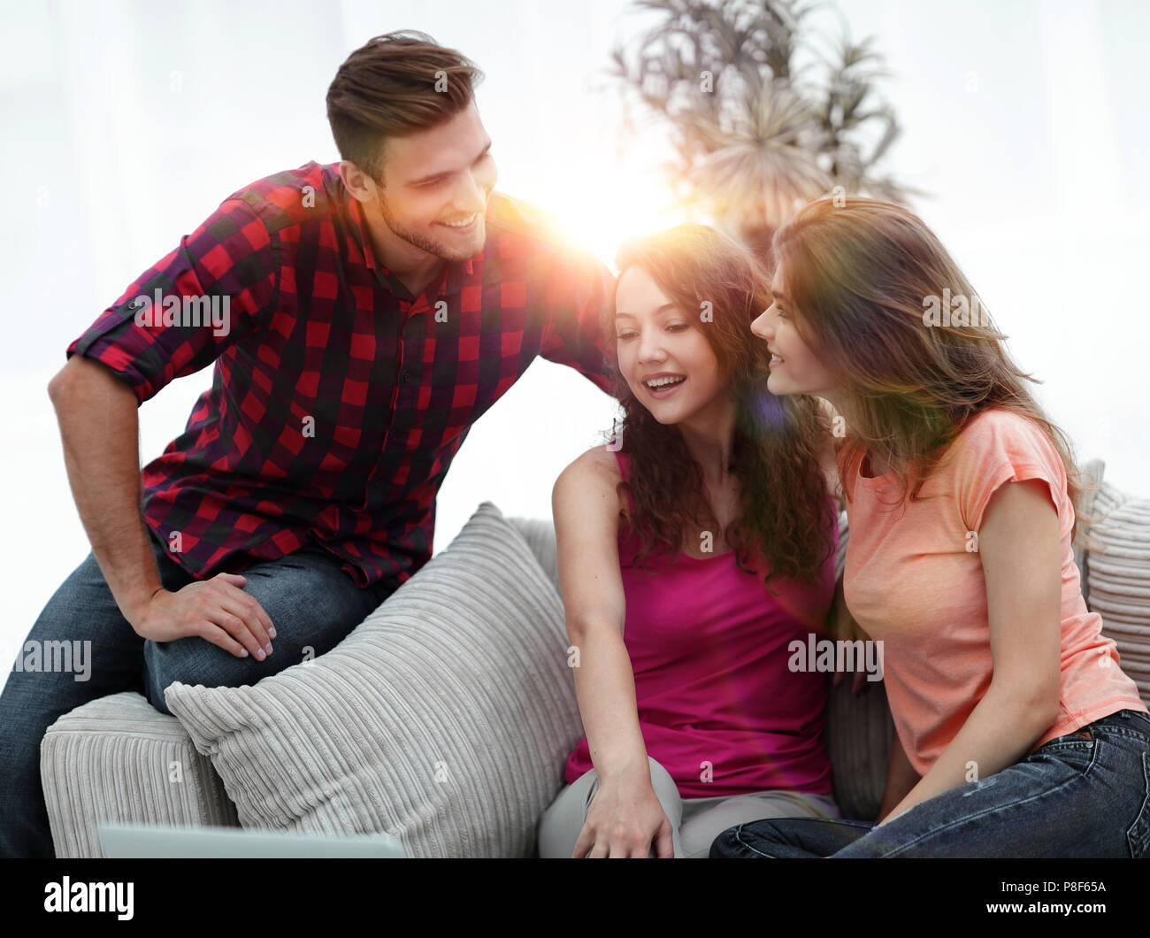group of students sitting on the sofa in the living room Stock Photo ...