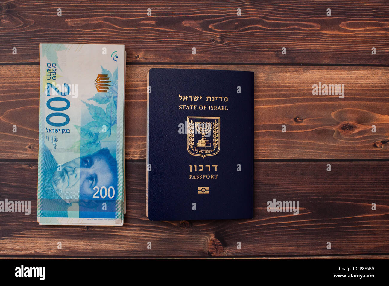 Stack of israeli money bills of 200 shekel and israeli passport Stock ...