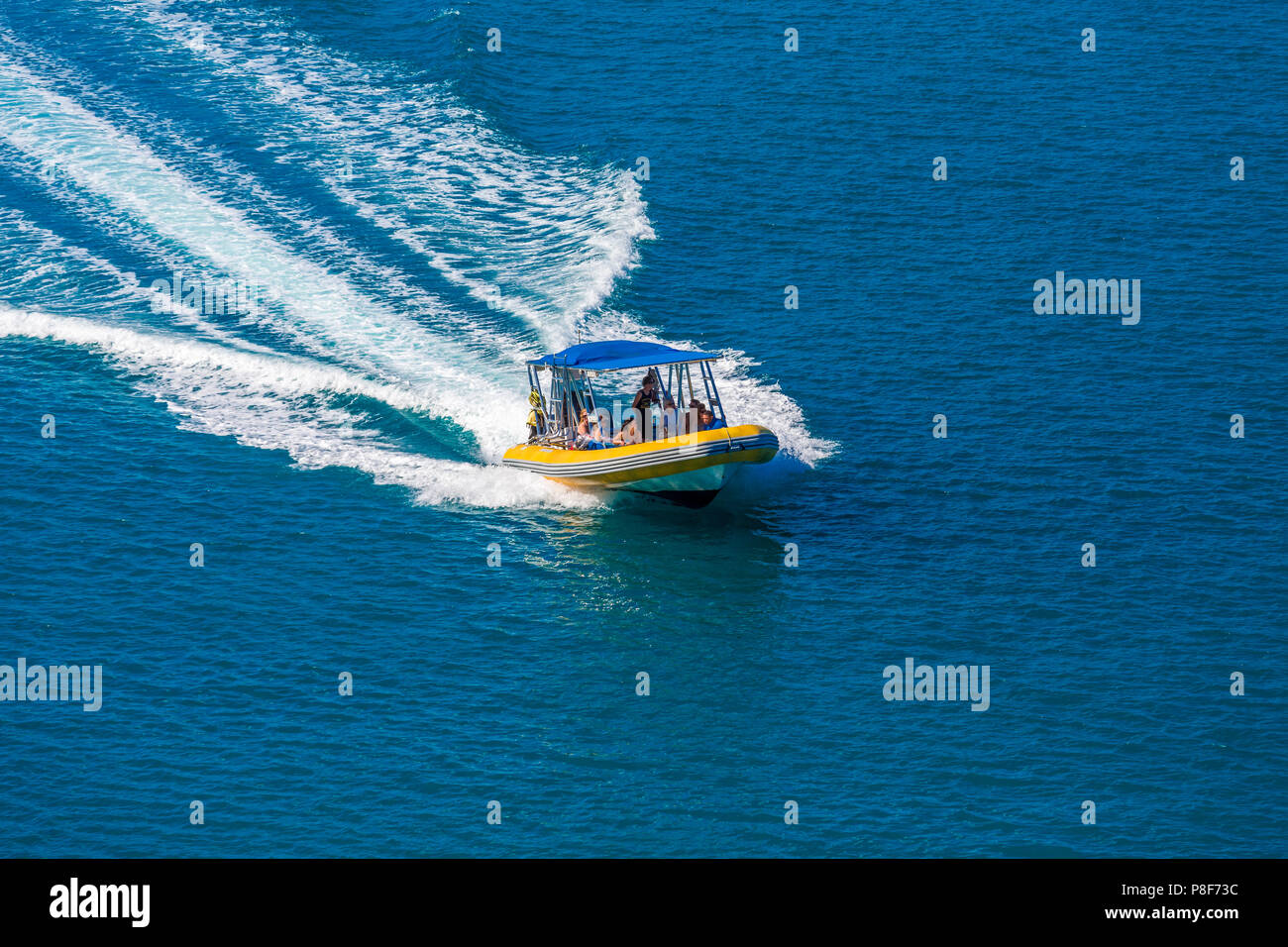 A Fast Pleasure Boat with Wake Through Blue Water Stock Photo - Alamy
