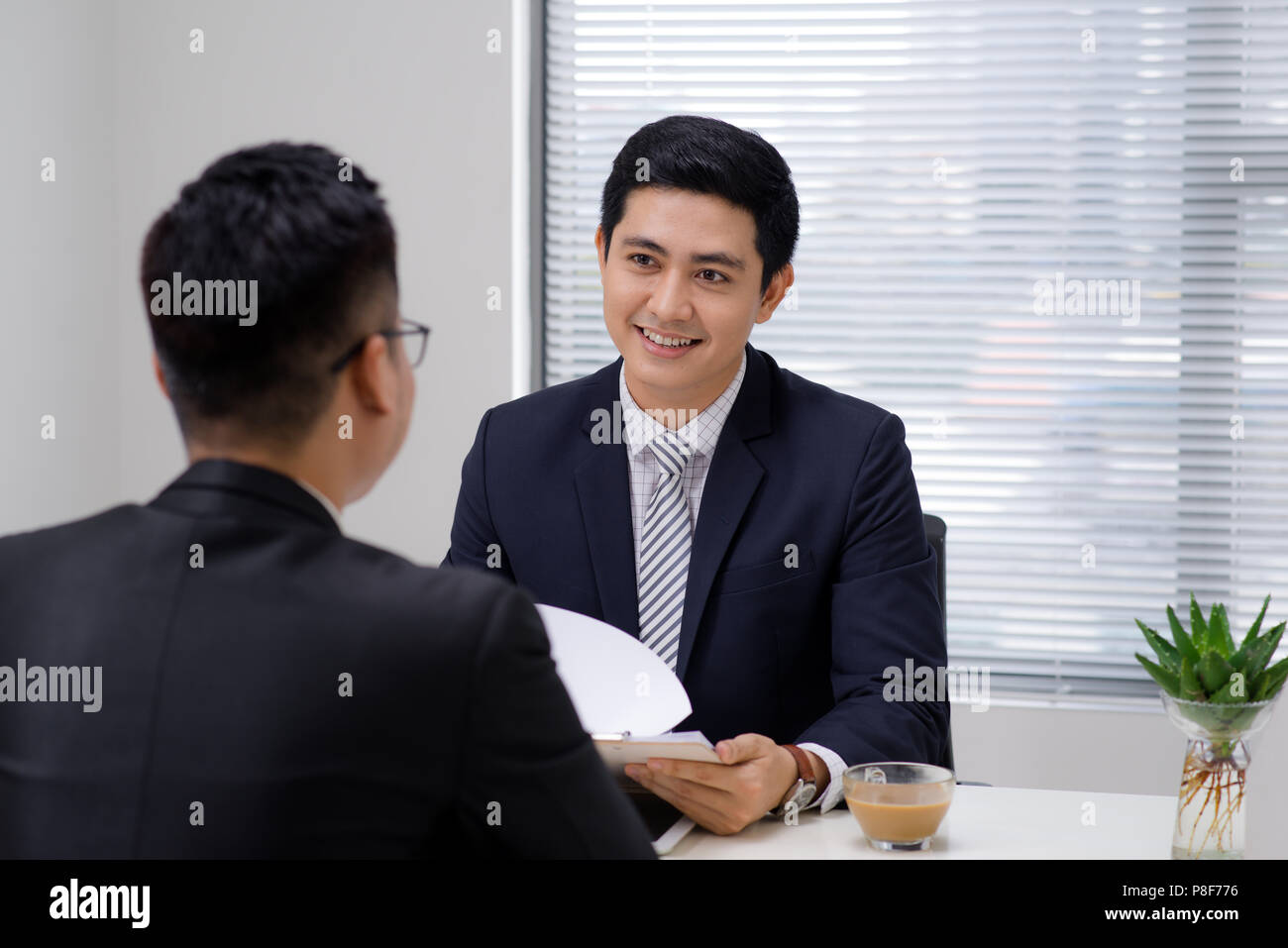 Job interview of two business professionals. Greeting new colleague ...
