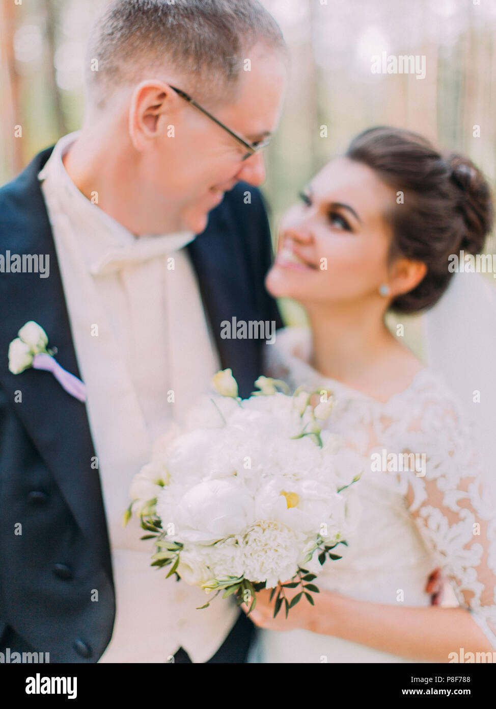Wonderful wedding bouquet of white peonies in the hands of the happy ... Wonderful wedding bouquet of white peonies in the hands of the happy ...