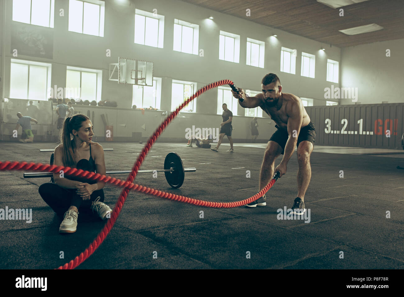 Men with battle rope battle ropes exercise in the fitness gym Stock ...