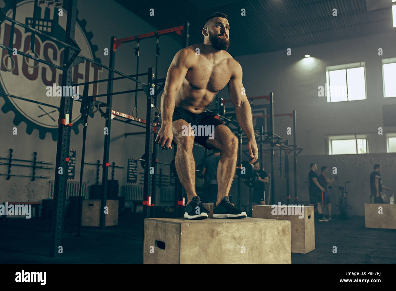 Man jumping during exercises in the fitness gym Stock Photo - Alamy