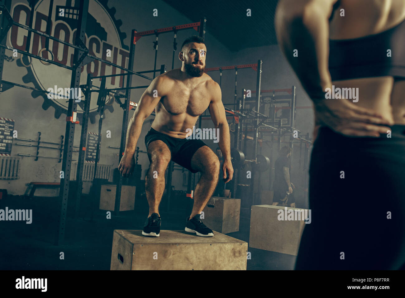 Man jumping during exercises in the fitness gym. CrossFit Stock Photo ...