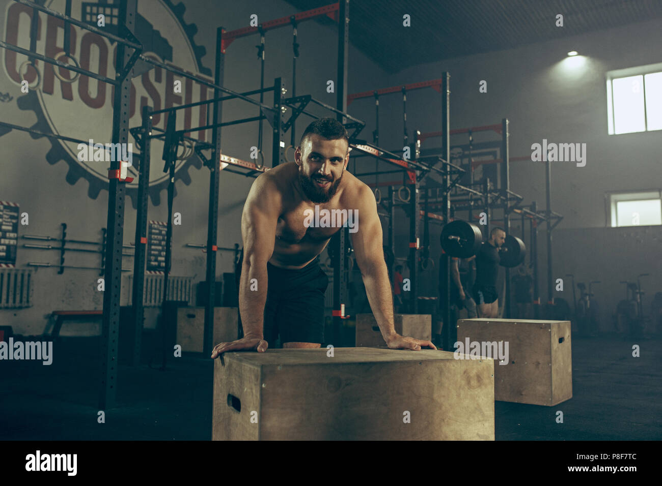 Man during exercises in the fitness gym Stock Photo - Alamy
