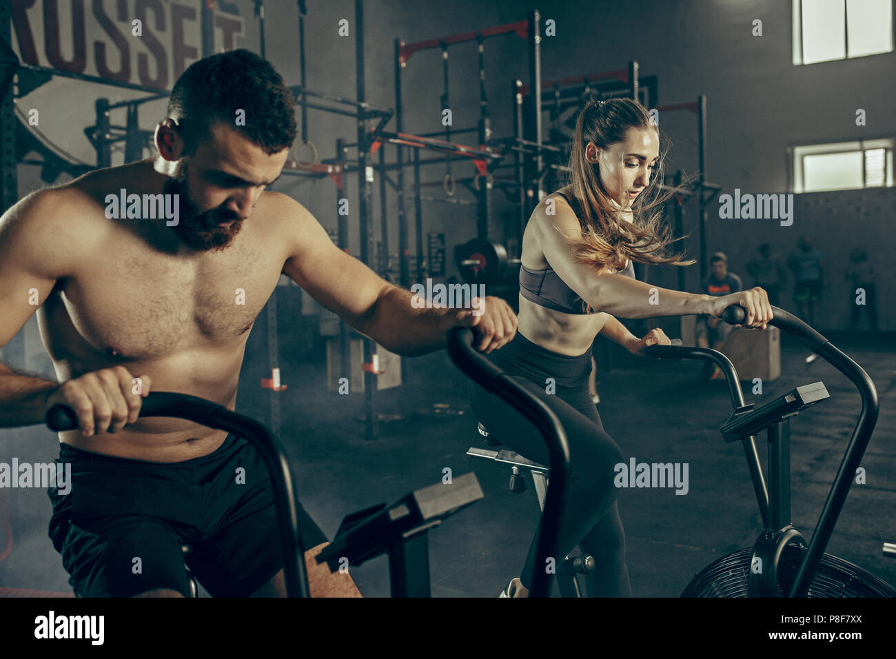 Man and woman during exercises in the fitness gym. CrossFit Stock Photo ...