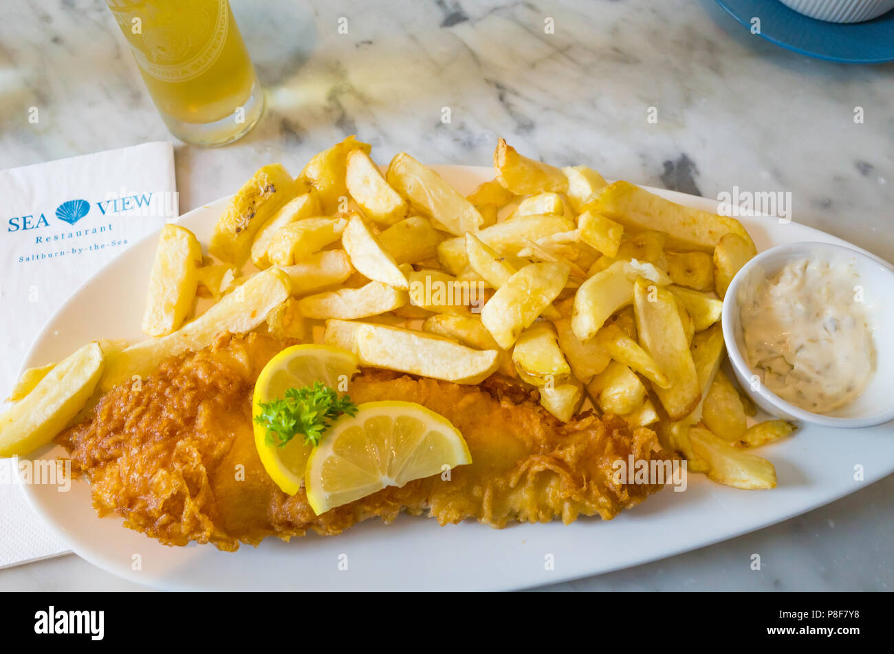 Fried Haddock and Chips and half a pint of lager traditional seaside ...