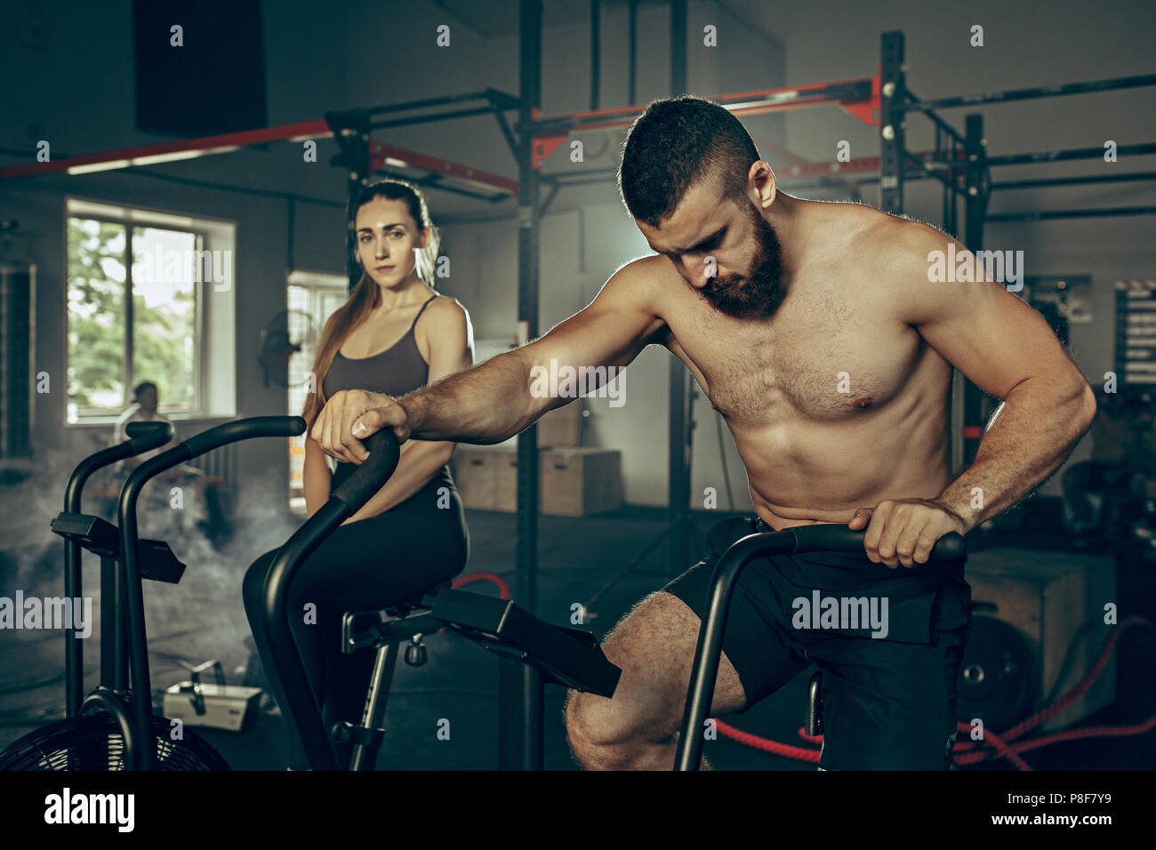 Man and woman during exercises in the fitness gym Stock Photo - Alamy