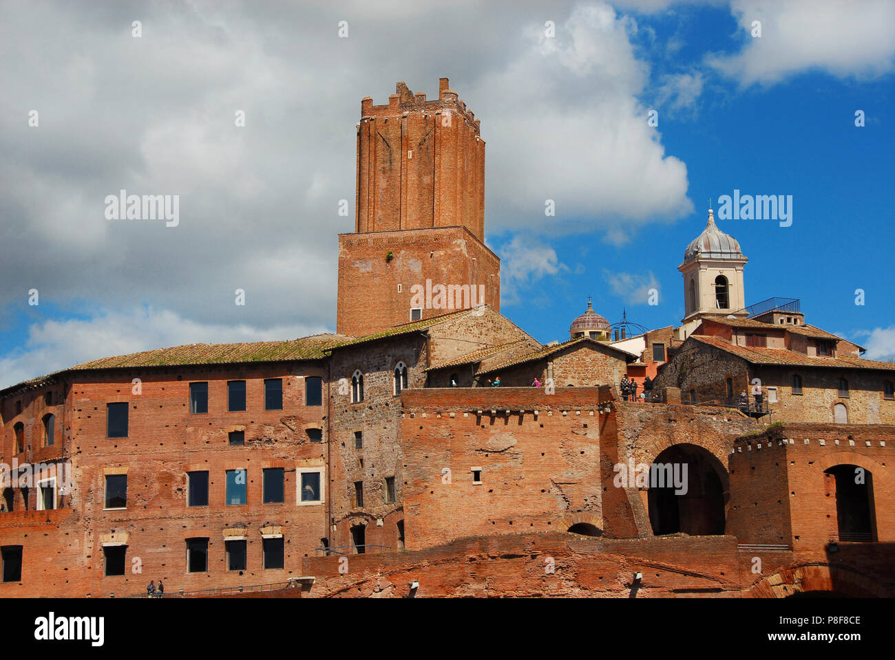 Tourists visit Trajan's Forum ancient ruins in Rome, with the medieval ...