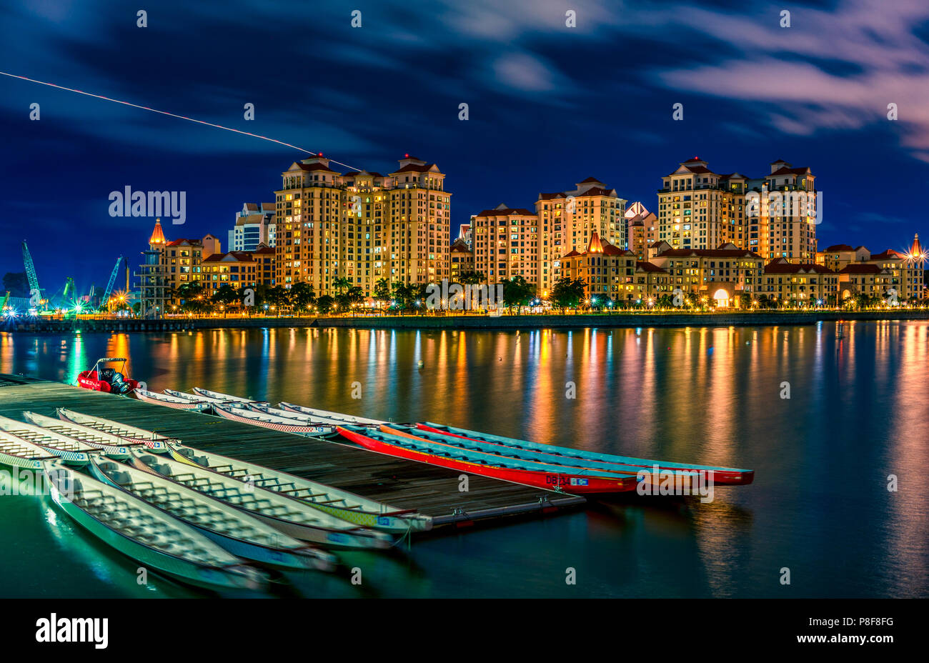 View of Illuminated Cityscape Waterfront Against Dramatic Sky and ...