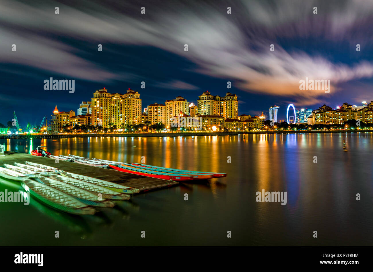View of Illuminated Cityscape Waterfront Against Dramatic Sky and ...