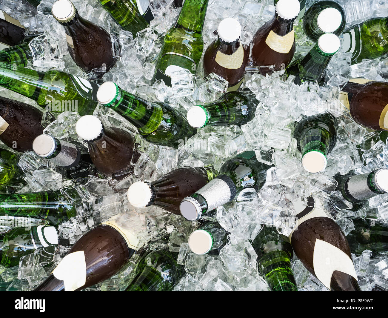 Cubes of ice and colorful bottles with cold beer Stock Photo - Alamy