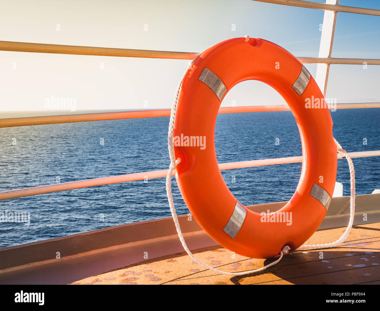 Bright, orange lifebuoy on the top deck of the cruise liner Stock Photo ...