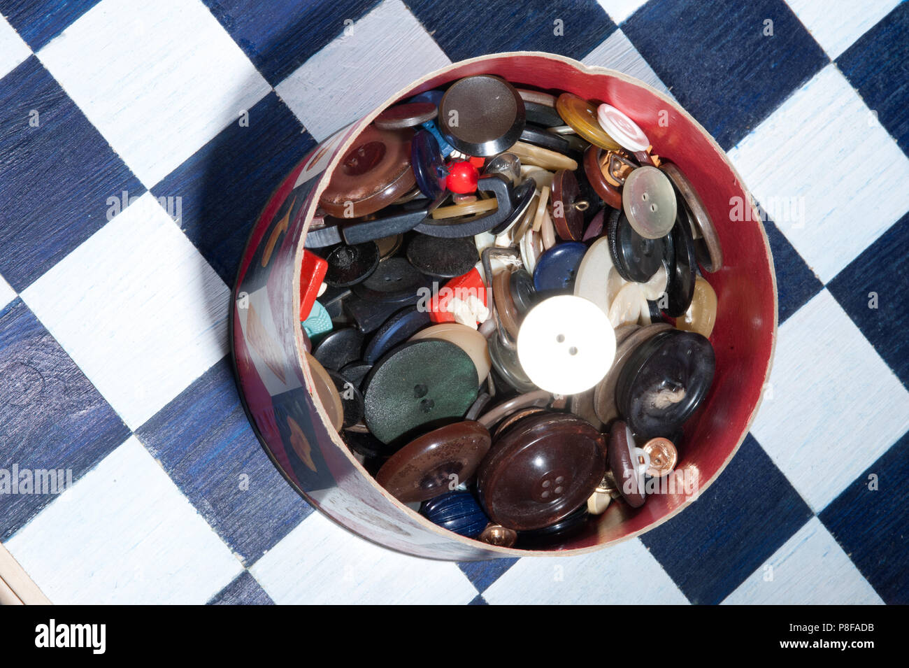 many buttons in can on chess board Stock Photo - Alamy