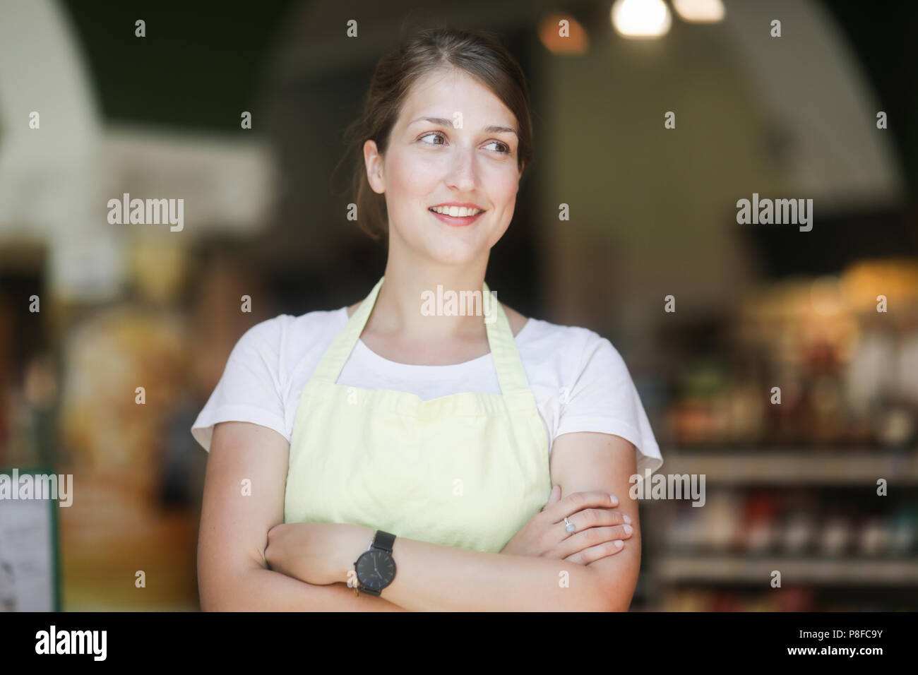 Woman standing sideways arms folded hi-res stock photography and images - Alamy