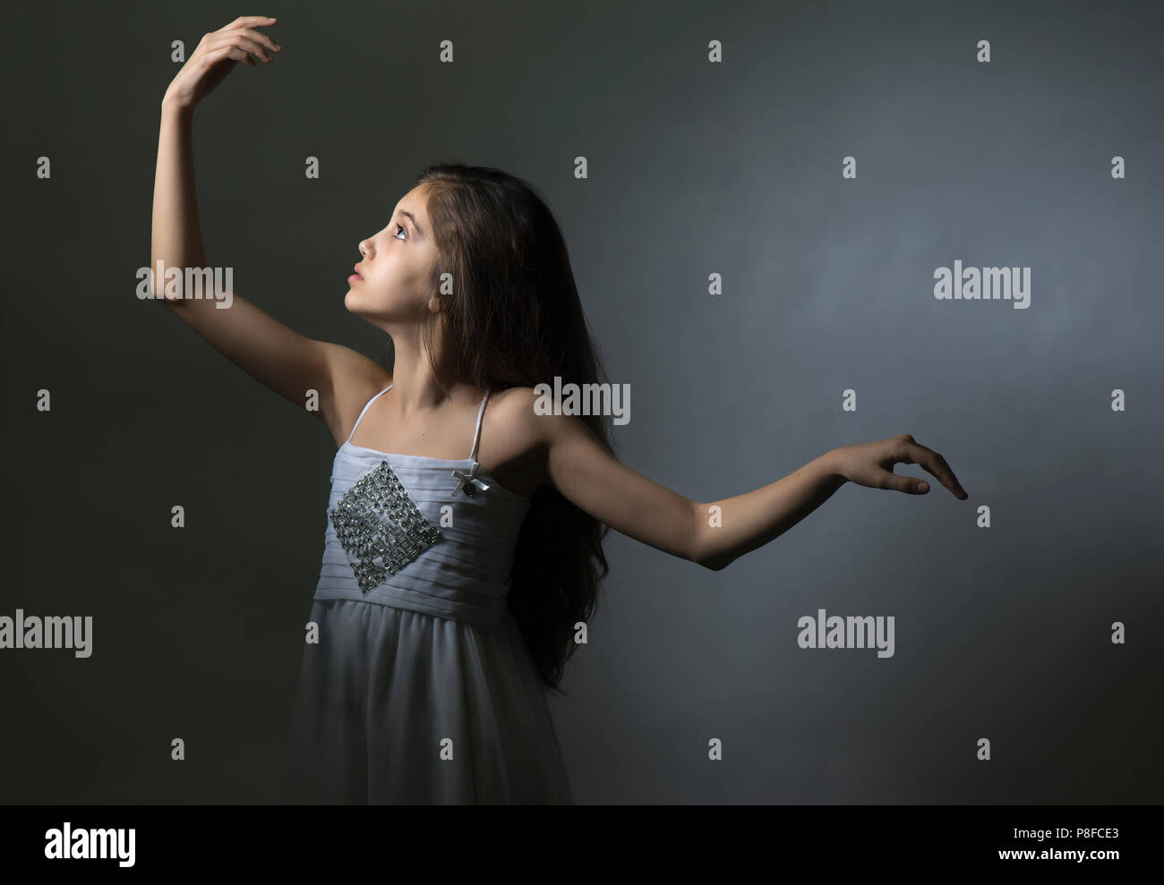 Portrait of a girl in a dress dancing Stock Photo - Alamy