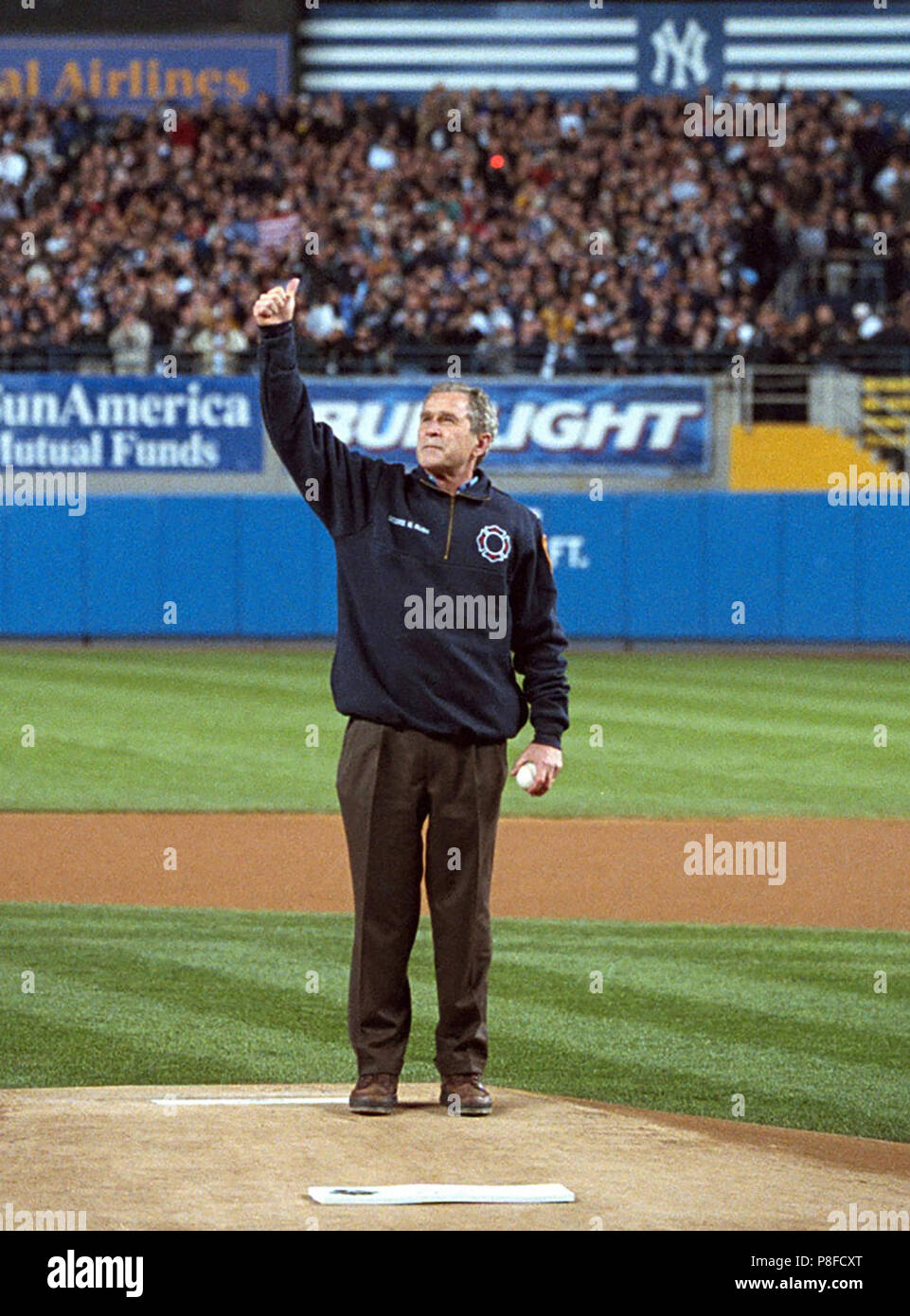 President George W. Bush gives a thumbs-up as he stands on the mound at ...