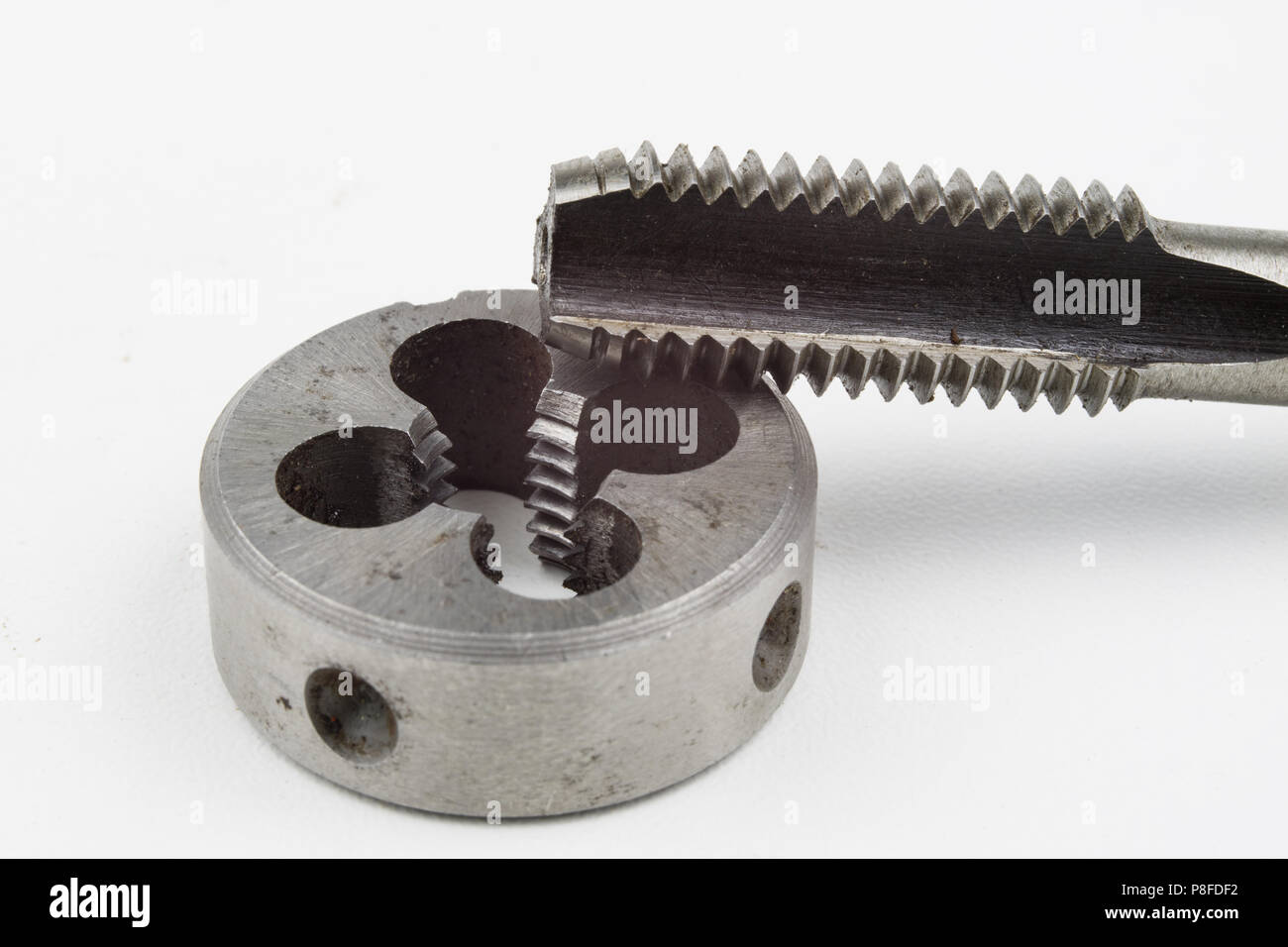 Device for making threads in a screw. Metalworking accessories. White ...