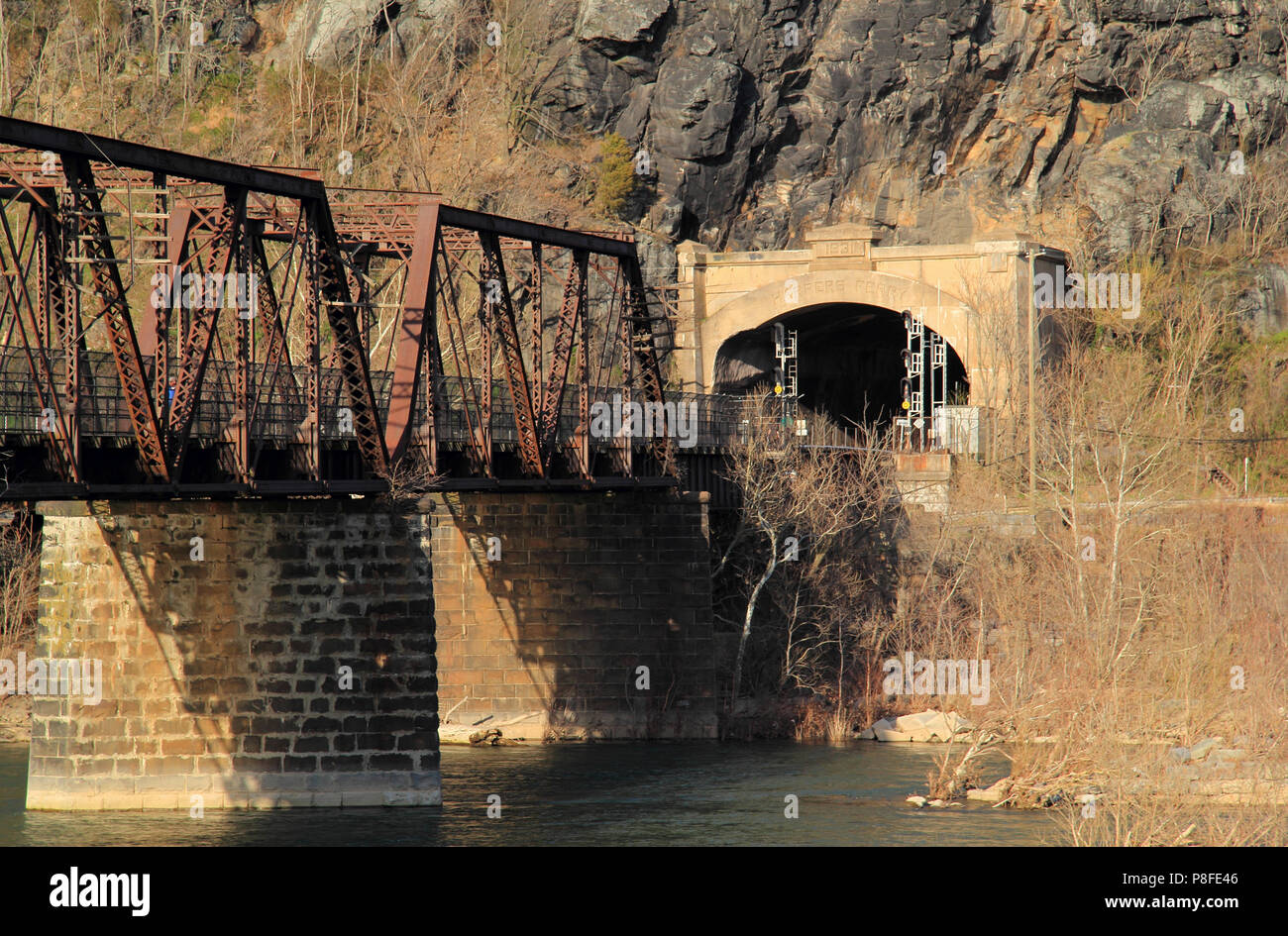 A truss bridge crosses the Potomac River and connects the historic town ...