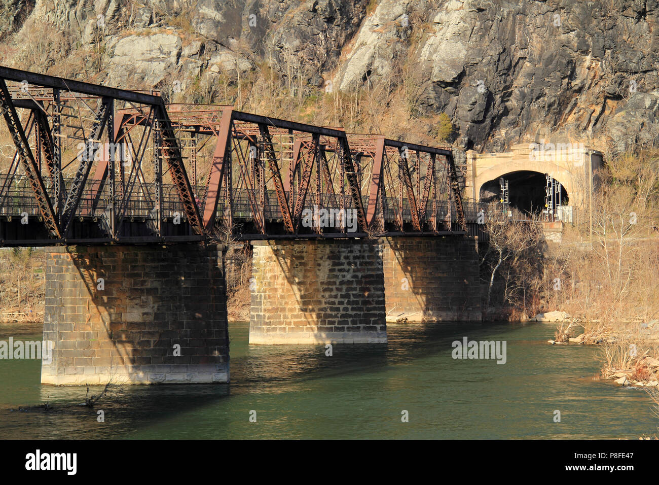 A truss bridge crosses the Potomac River and connects the historic town ...