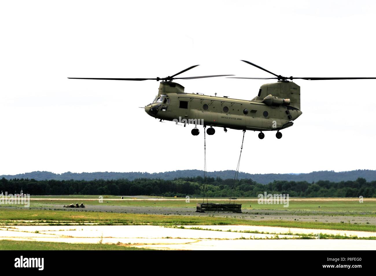 An aircrew of a Chinook helicopter picks up a mock ammunition pallet ...
